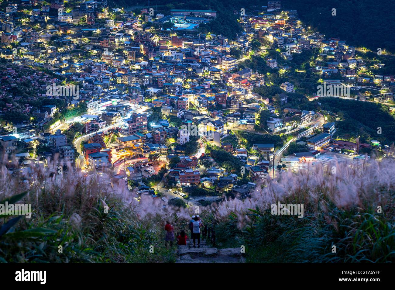 Overlooking the lively and colorful valley villages at night. Jiufen ...