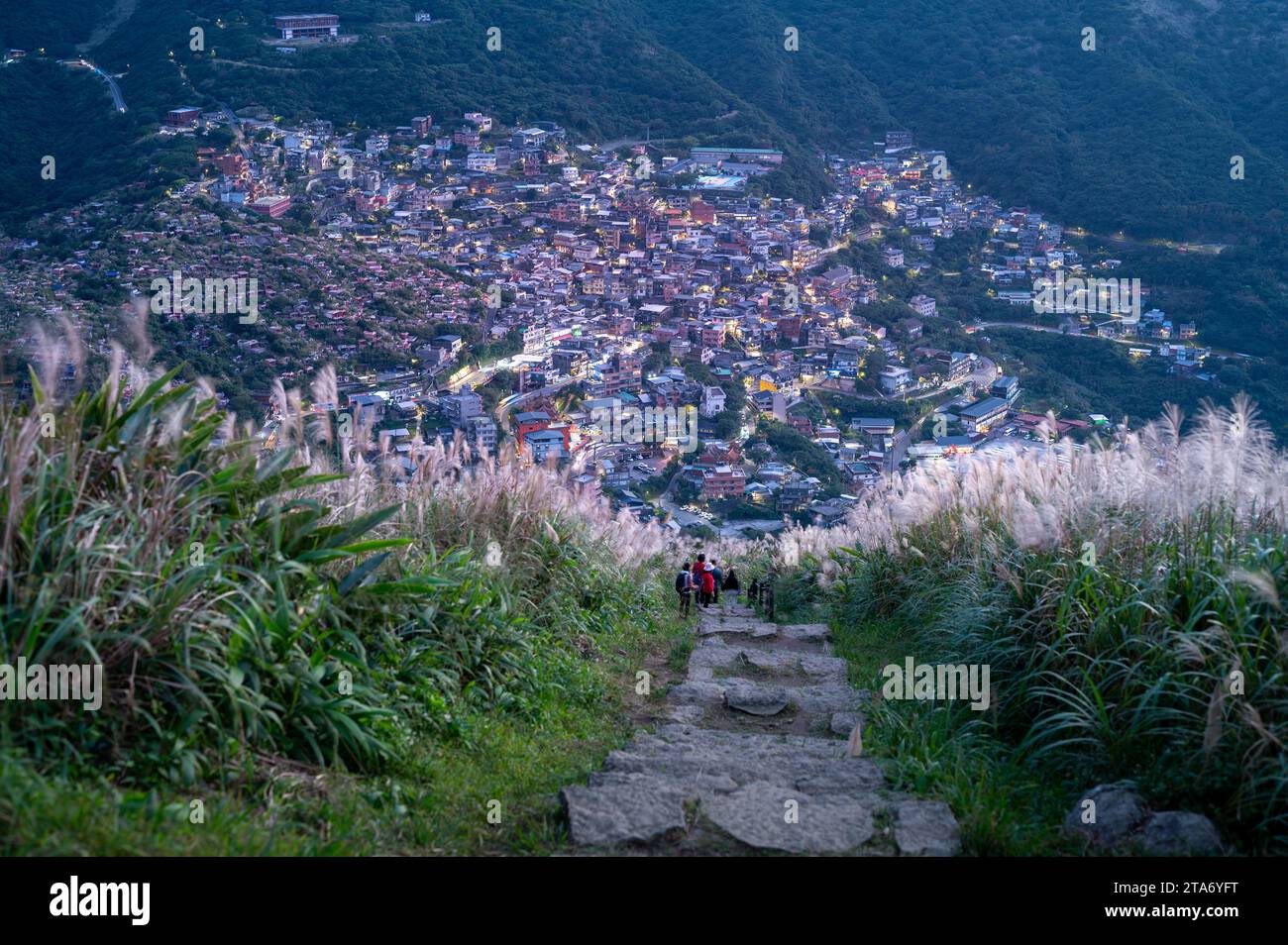 Overlooking the lively and colorful valley villages at night. Jiufen ...