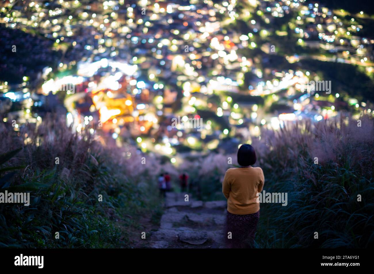 Overlooking the lively and colorful valley villages at night. Jiufen ...