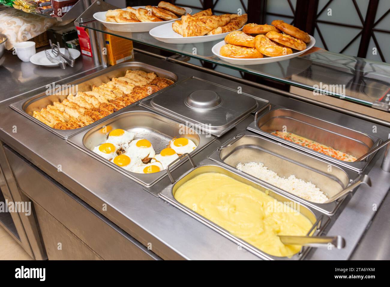 Fast food bistro, food in metal trays, cutlet salads garnish on the ...