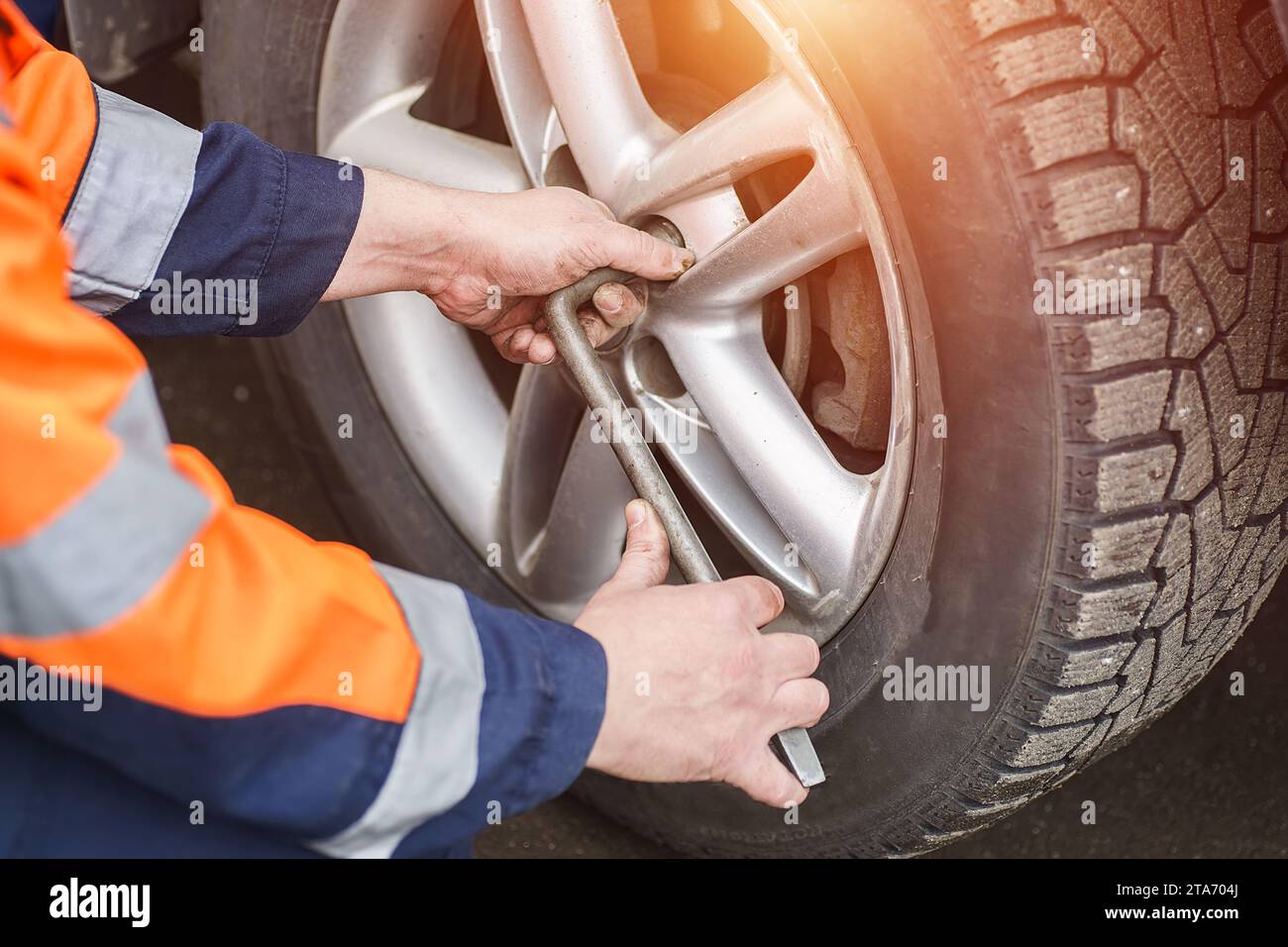Man fitting new tyre hi-res stock photography and images - Alamy