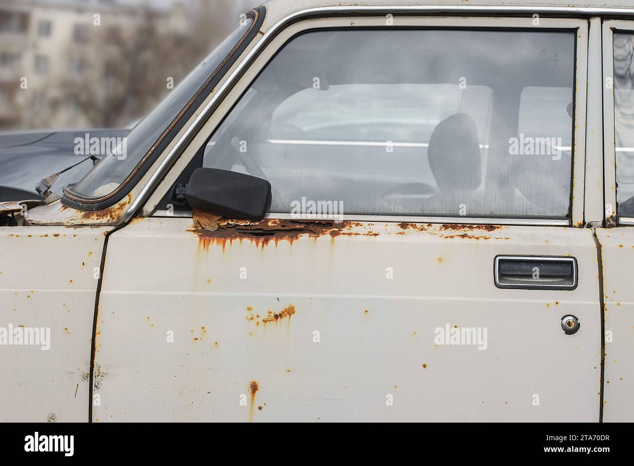 Sheet metal corrosion over wheel of old white car. Rusty messy surface ...