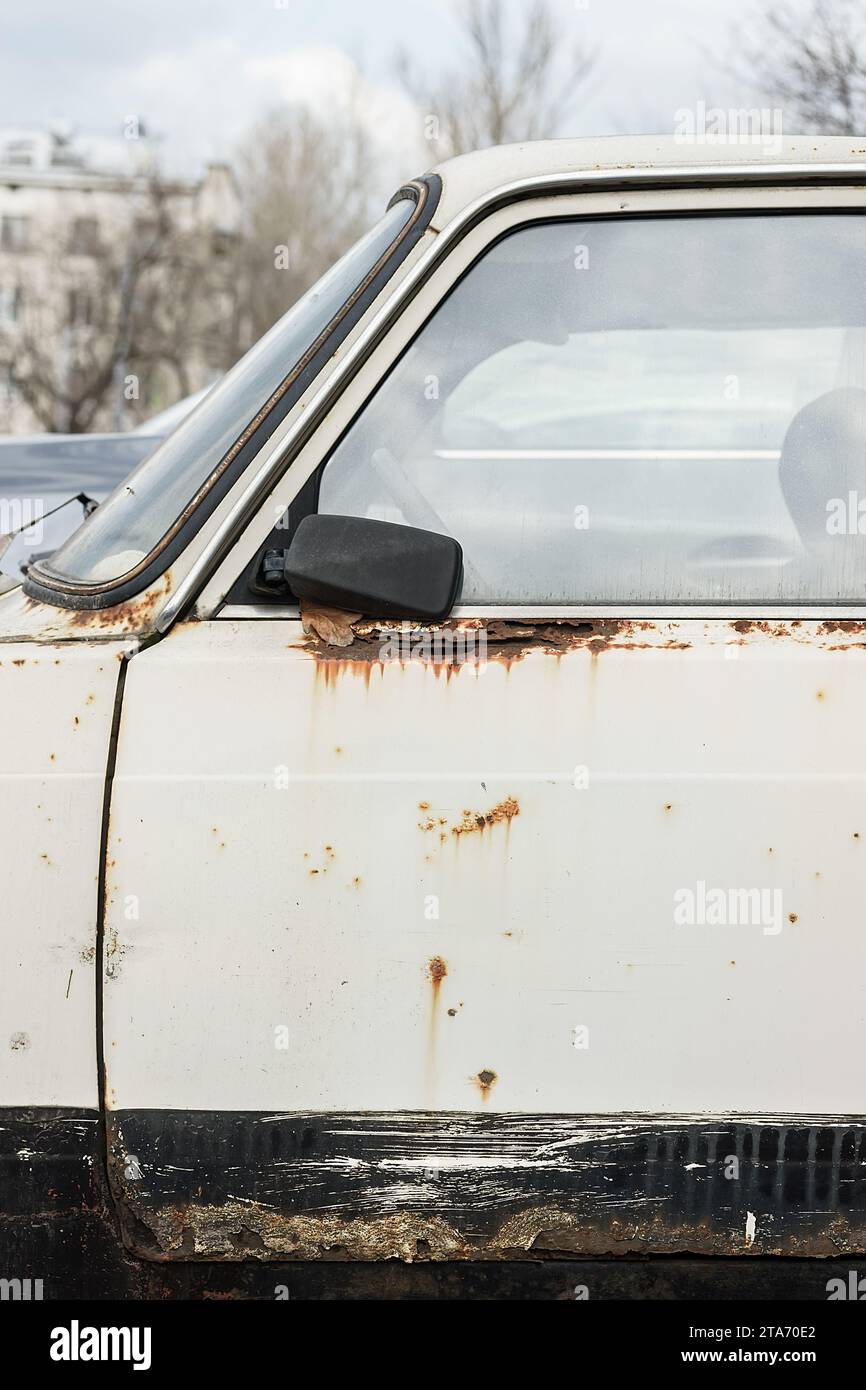 Sheet metal corrosion over wheel of old white car. Rusty messy surface ...
