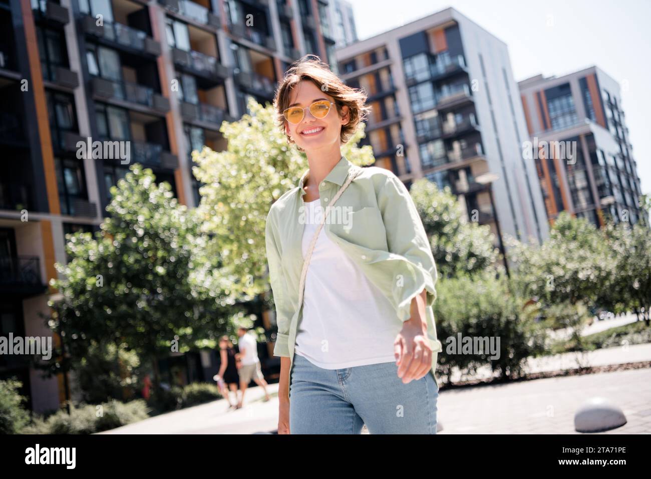 Photo of adorable positive girl dressed stylish clothes going park ...