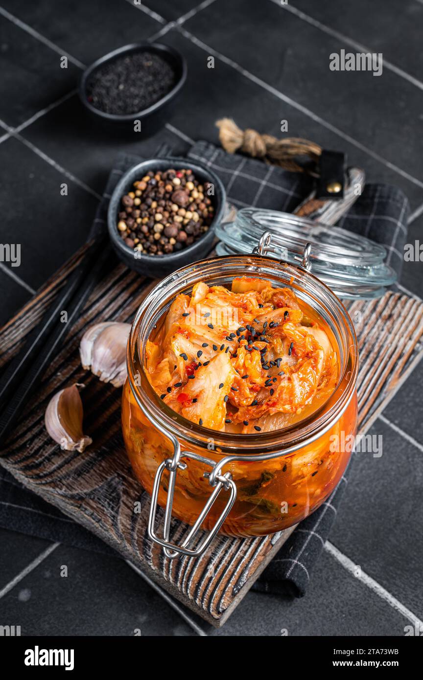 Homemade kimchi in a glass jar, traditional Korean cuisine. Black ...