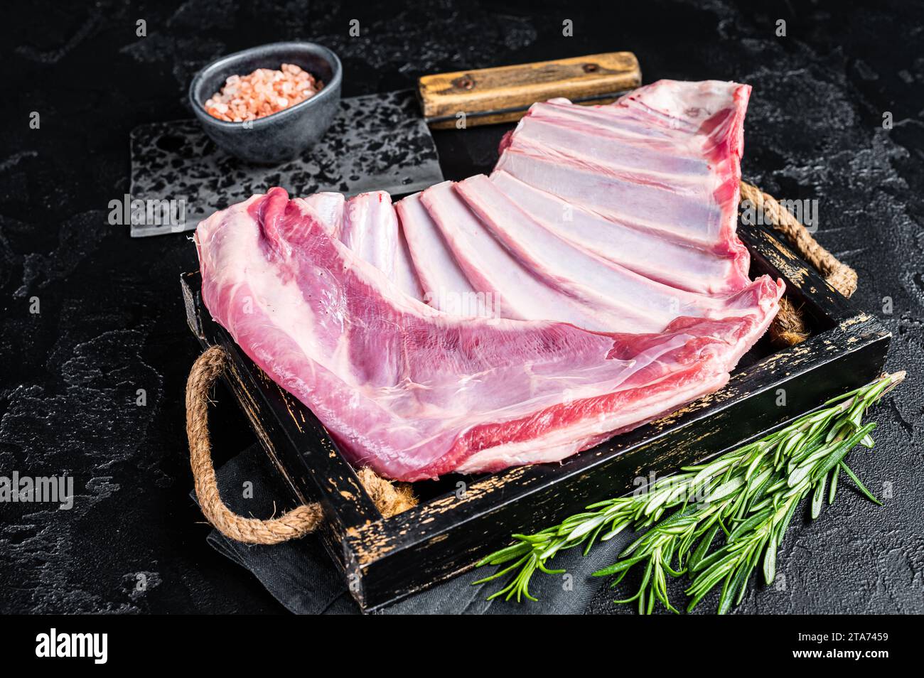 Butcher table with Rack of lamb, raw mutton ribs with meat cleaver ...