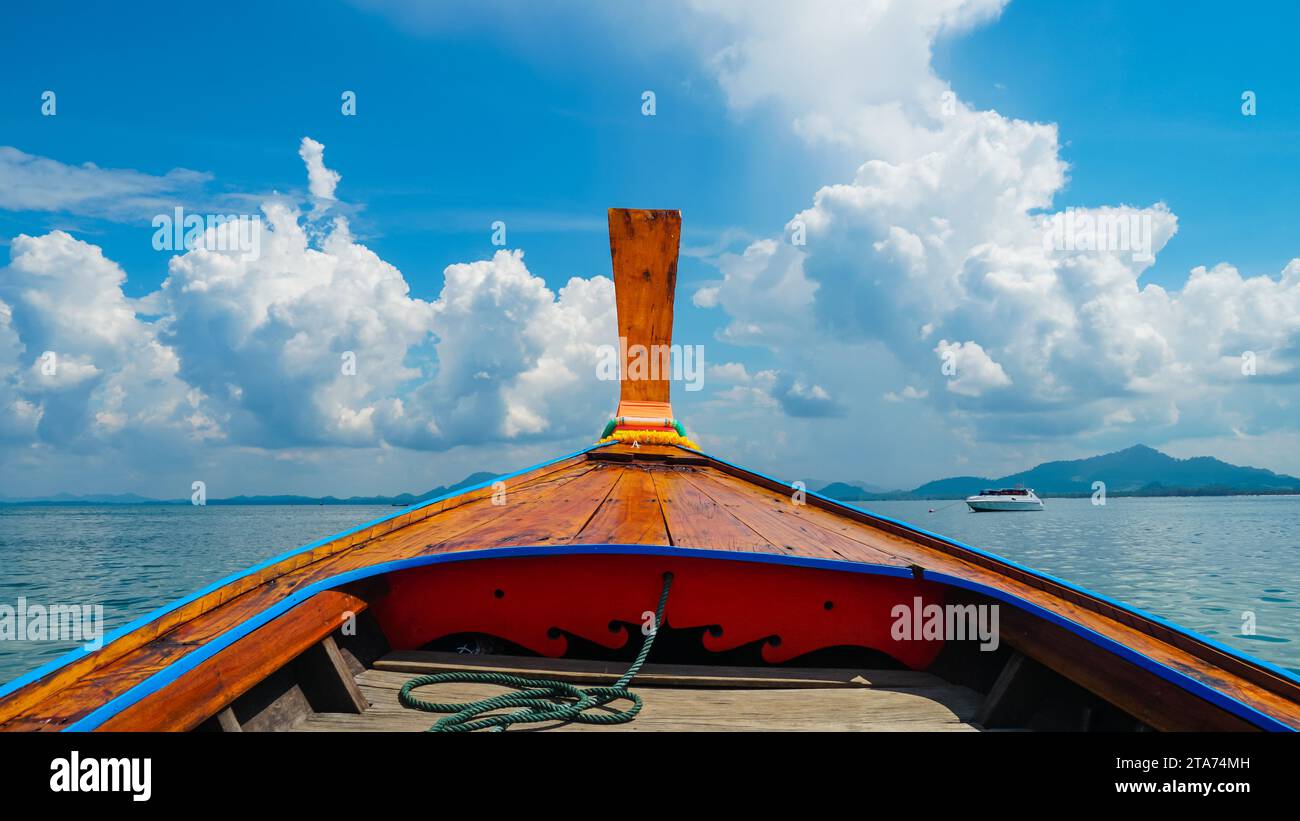 Traditional wooden longtail taxi boat nose with decoration flowers and ...