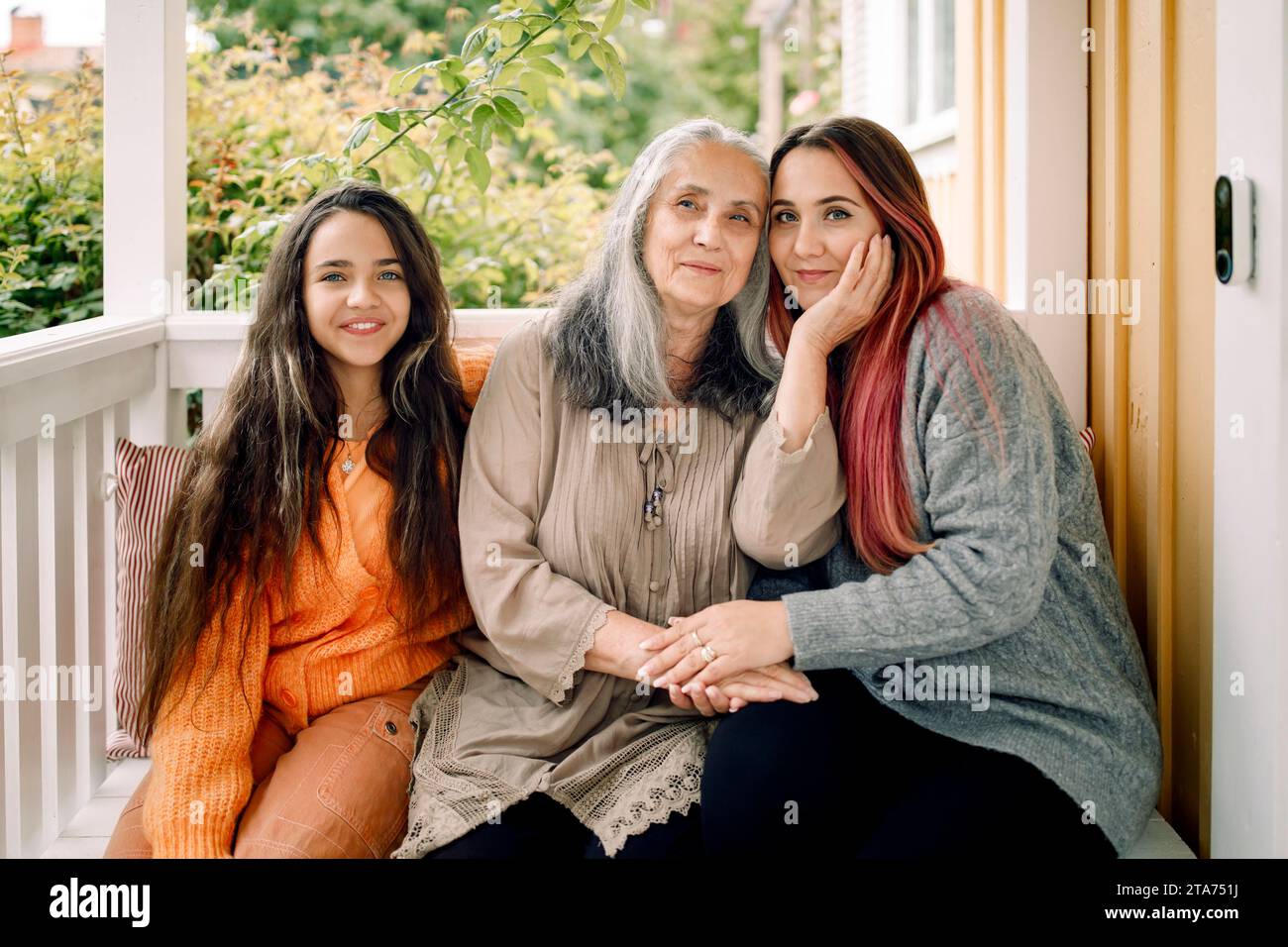Portrait of multi-generation family sitting together at porch Stock ...