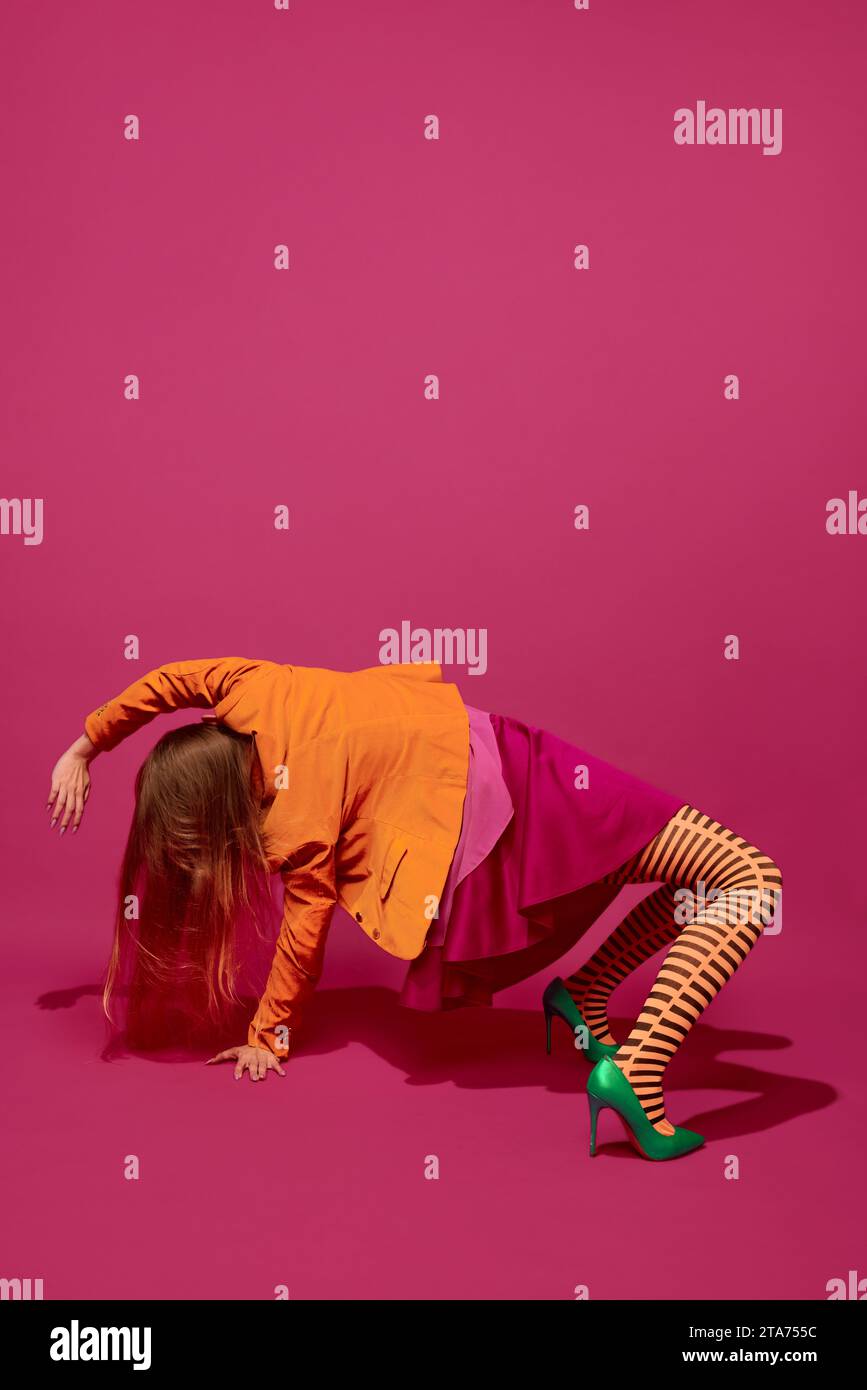 Self-expression. Young weird woman in bright clothes posing in ...