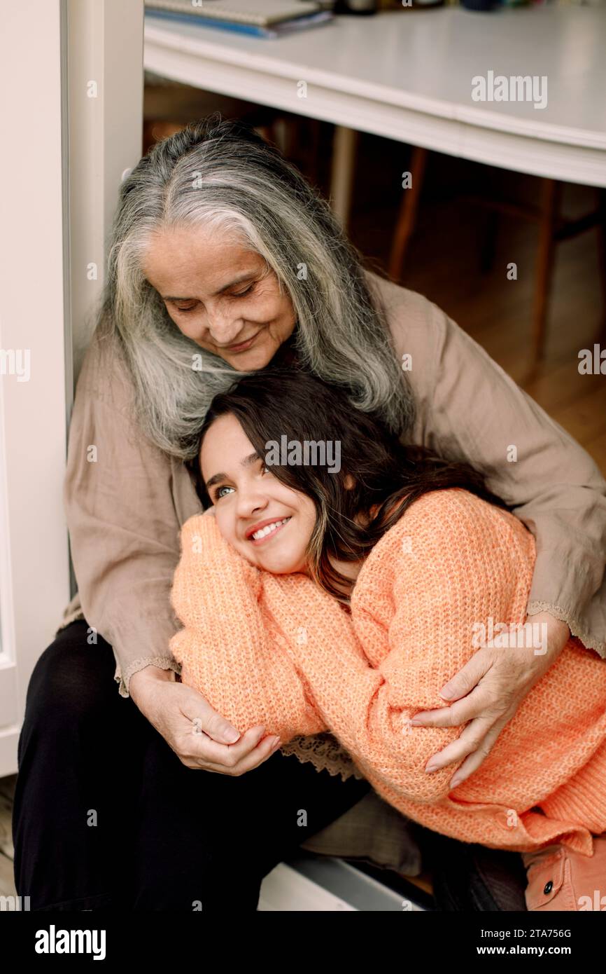 Woman embracing child sitting hi-res stock photography and images - Alamy