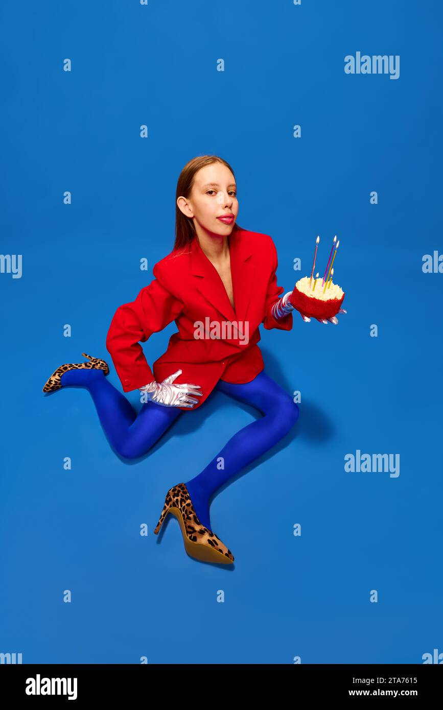 Young lady dressed unusual, freaky, bright outfit, wearing blue tights ...