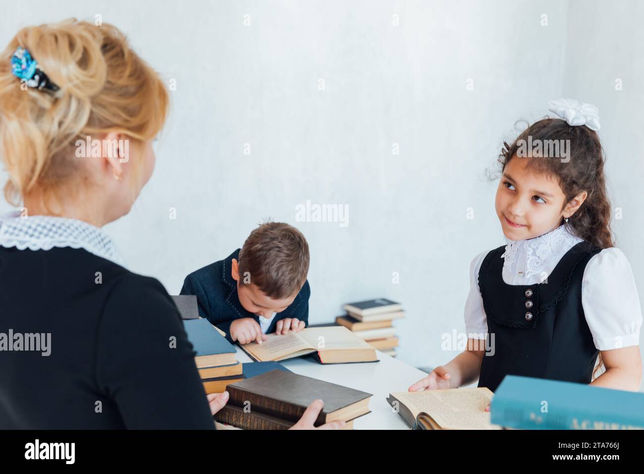 Teacher teaching children at school in lesson Stock Photo - Alamy