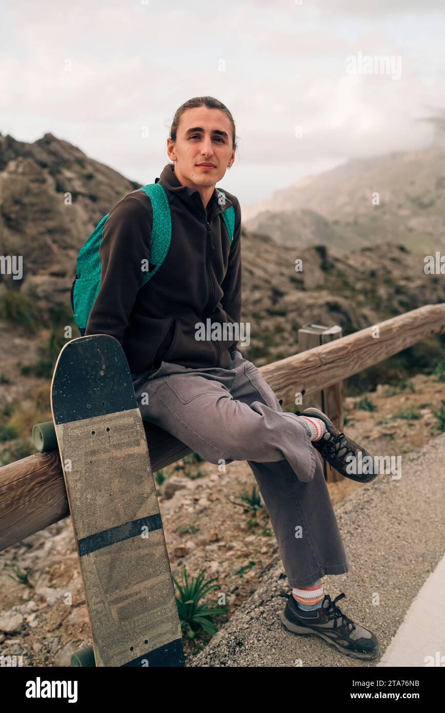 Man sitting on railing hi-res stock photography and images - Alamy