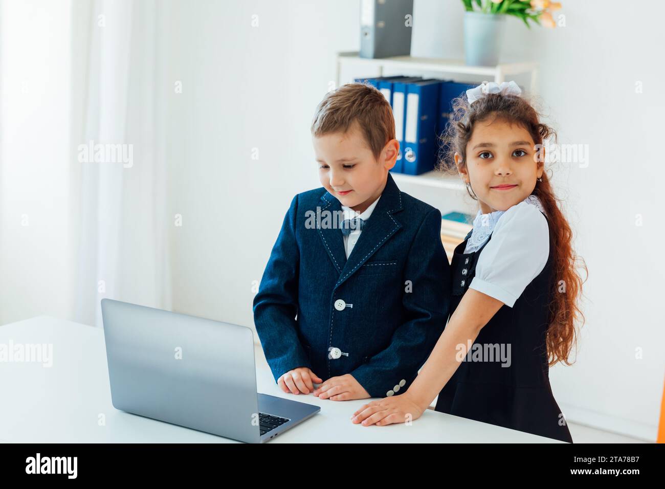 Boy and girl learning watching laptop Stock Photo - Alamy