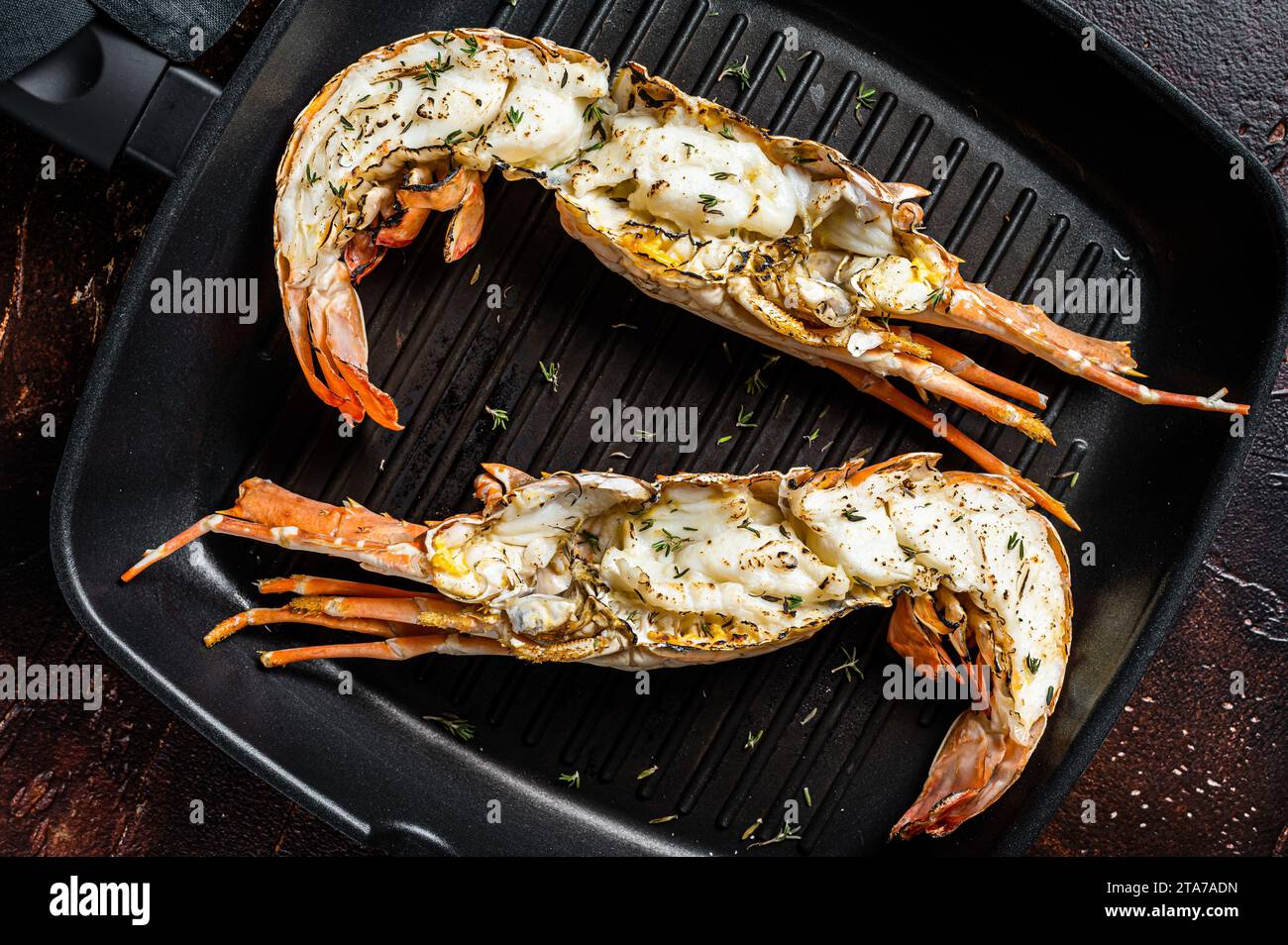 Delicious grilled and sliced Spiny lobster or sea crayfish. Dark ...