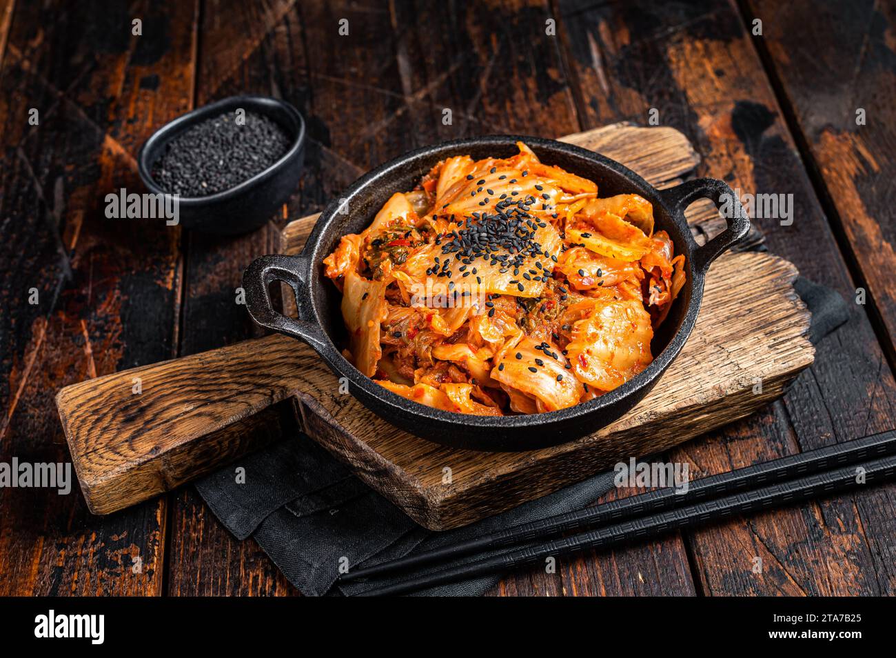 Kimchi salted and fermented chinese cabbage in a skillet. Wooden ...