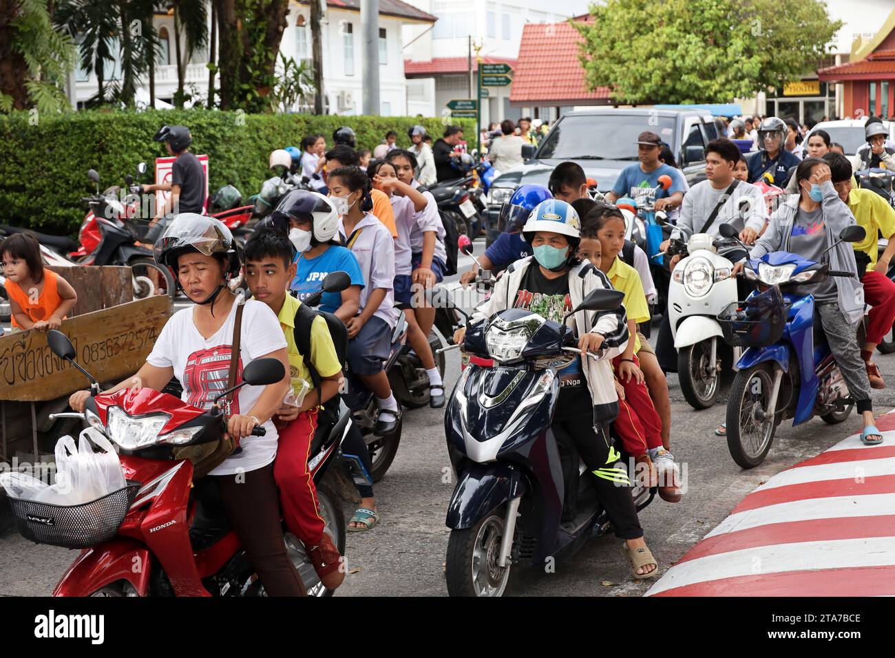 People riding motorbikes on city street Stock Photo - Alamy