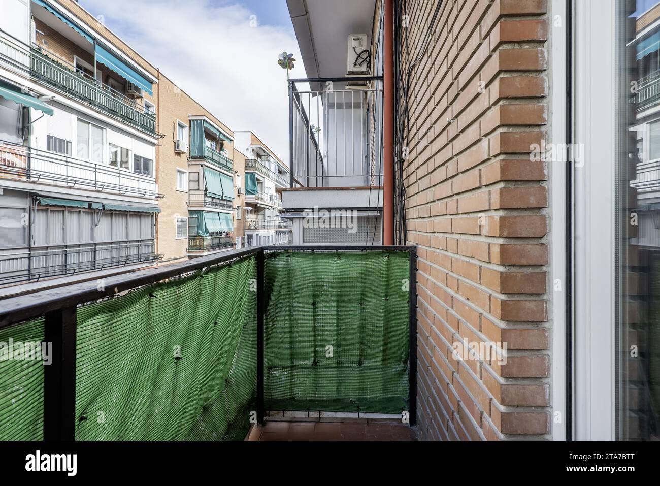 Small terrace of an apartment with black metal railing with opaque ...
