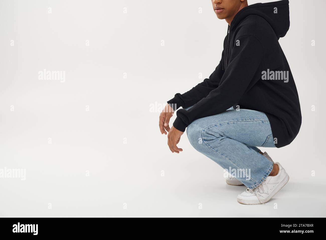 trendy african american male model in casual black hoodie and jeans ...