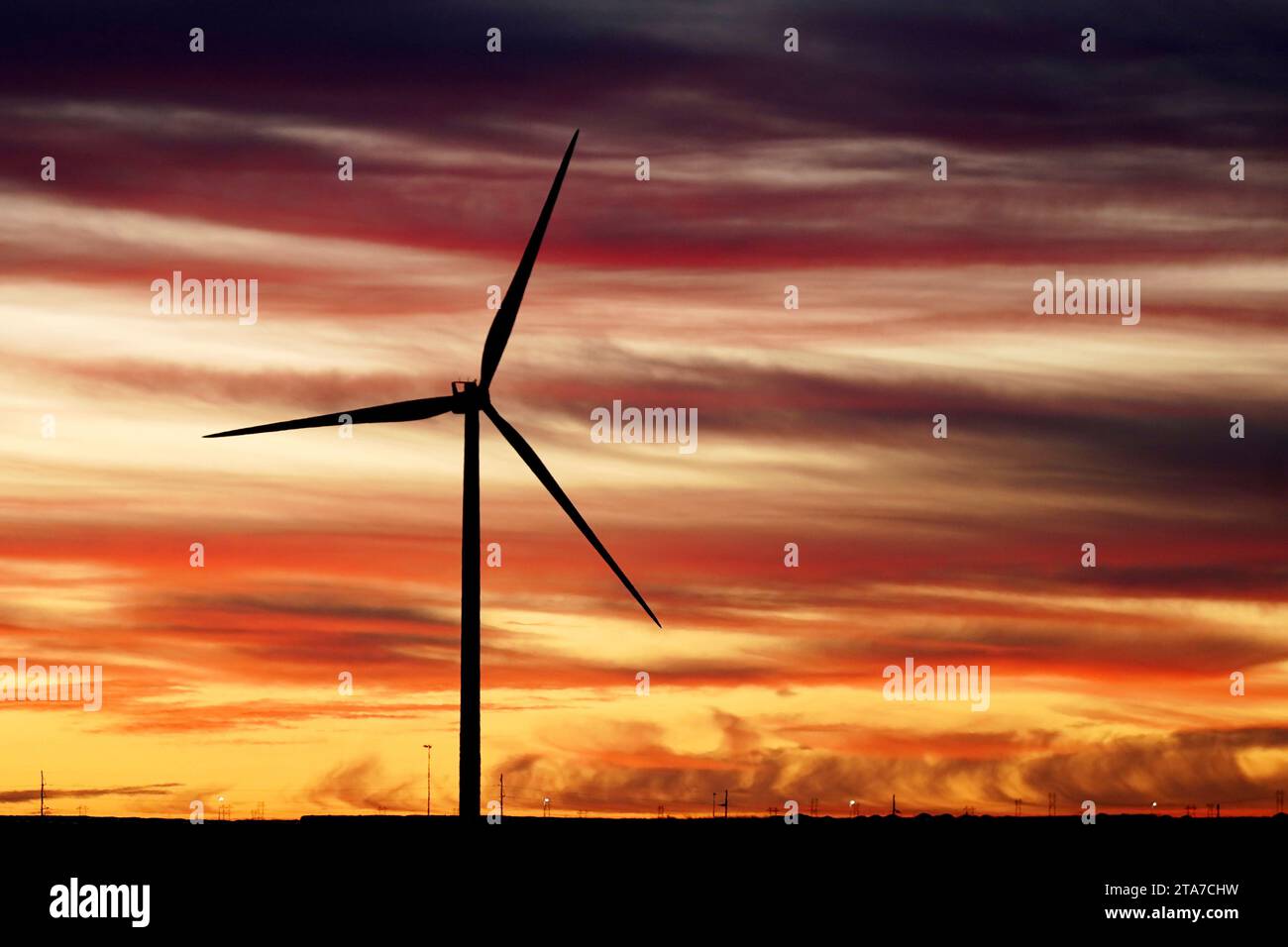 The sun rises behind a windmill before President Joe Biden's visit to ...