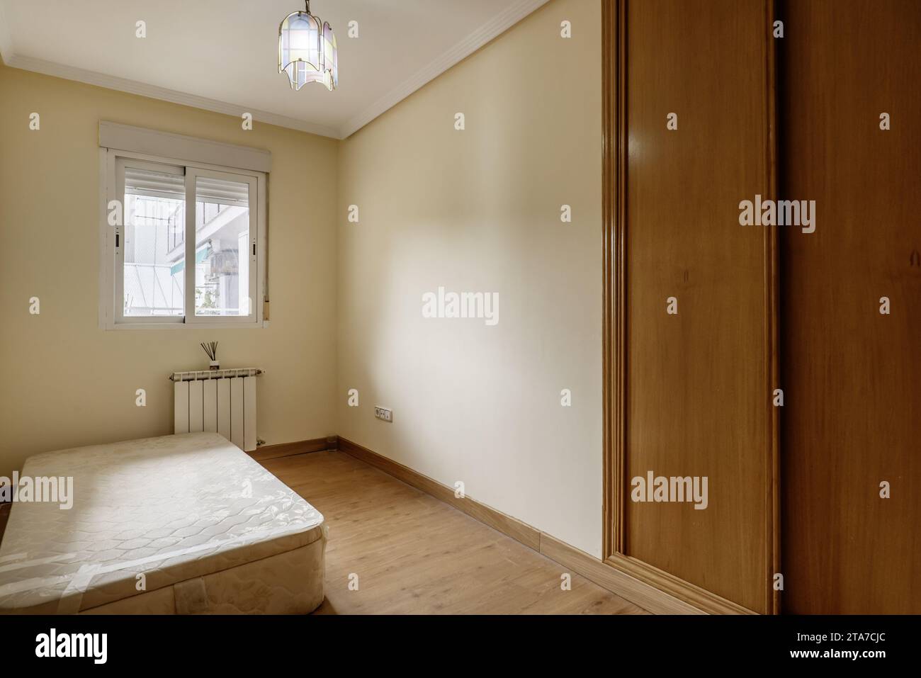 A small empty room with an old folding sofa Stock Photo - Alamy