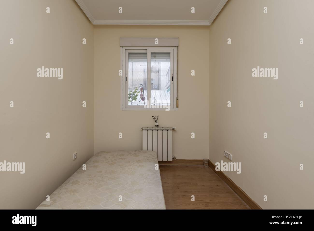 A small empty room with an old folding sofa Stock Photo - Alamy