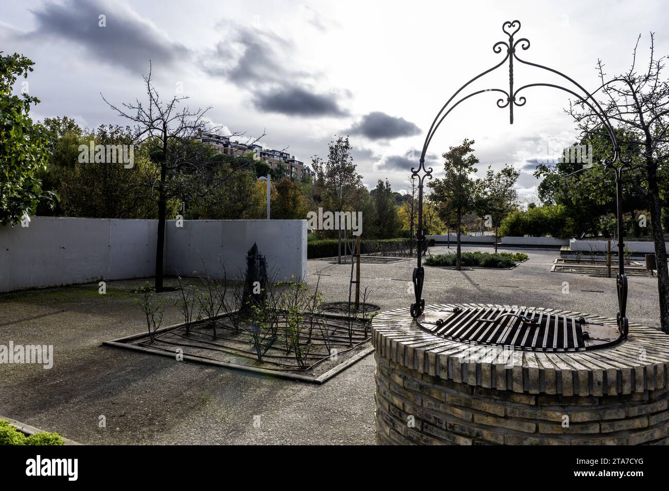 Wellhead built with bricks and metal cover located in an urban park ...