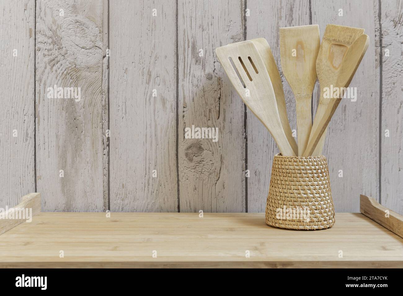 A fiber and cane container with wooden spatulas Stock Photo - Alamy