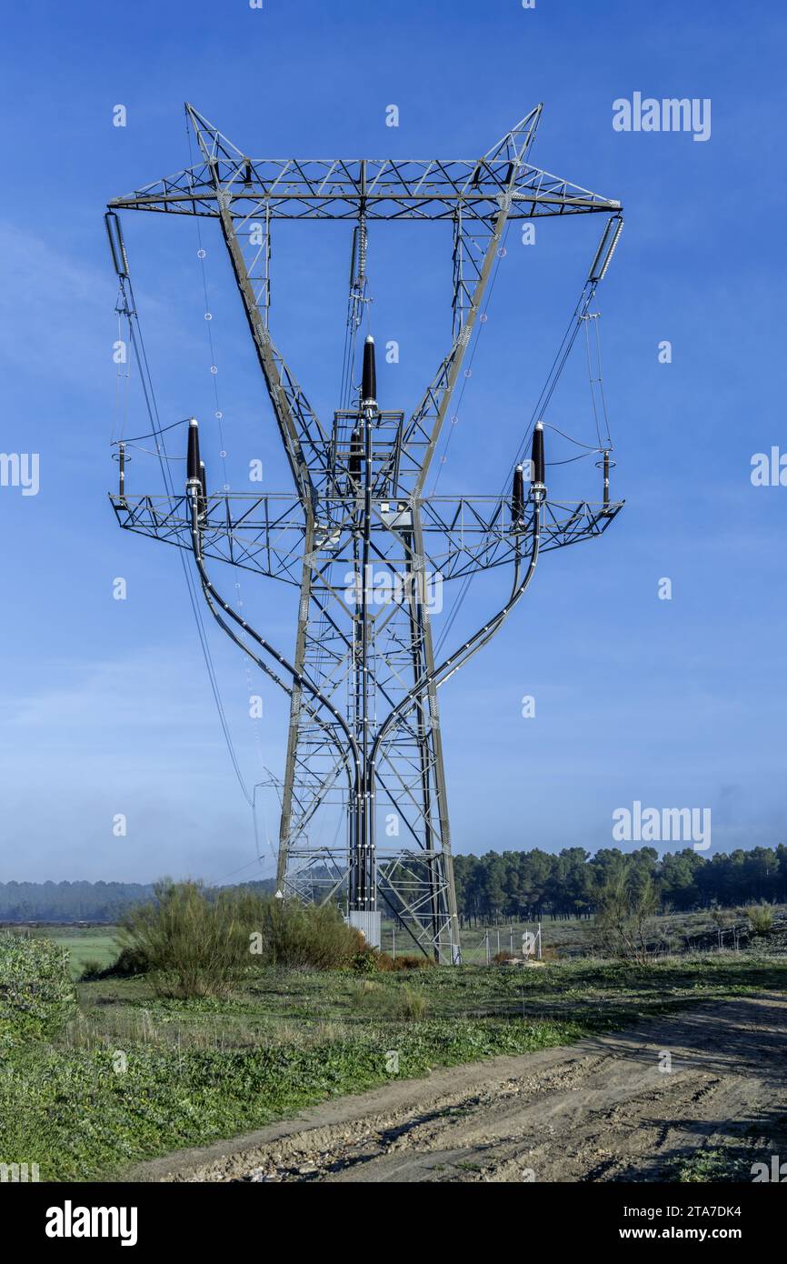 High voltage pylons in the middle of the countryside Stock Photo - Alamy