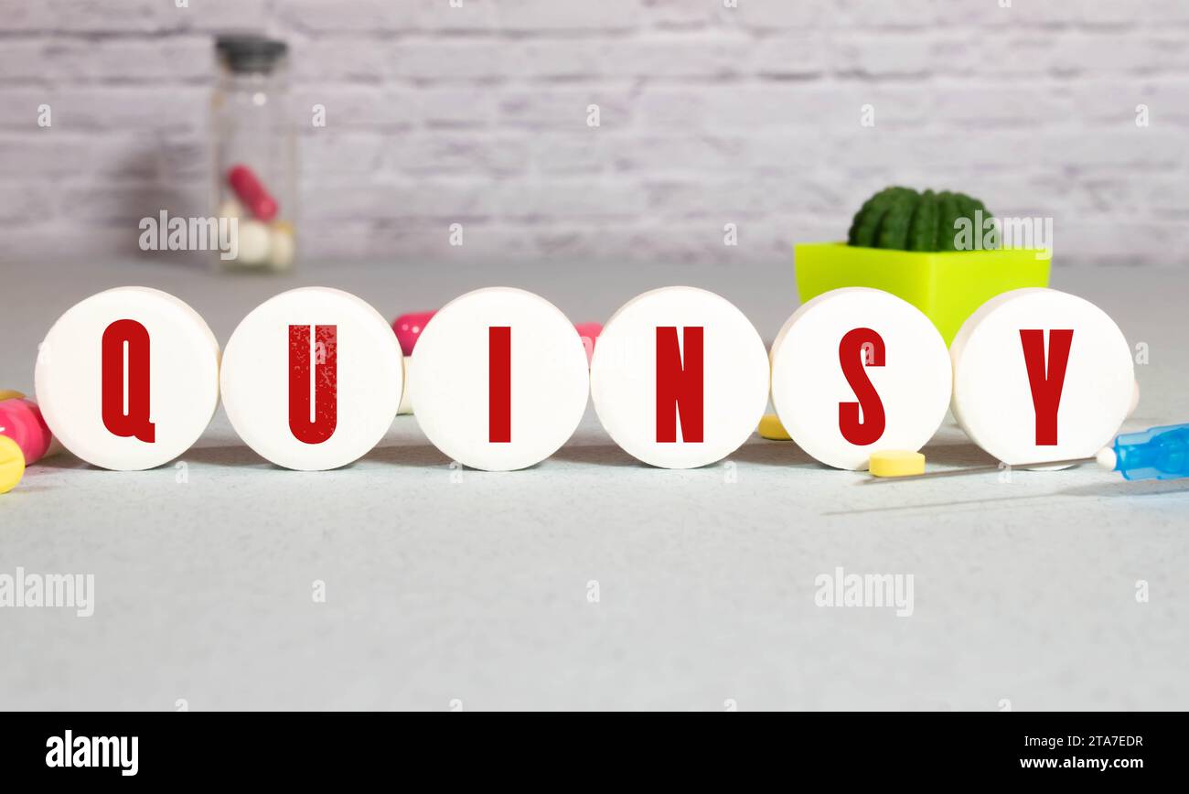 quinsy, text on wood block, blue background Stock Photo - Alamy