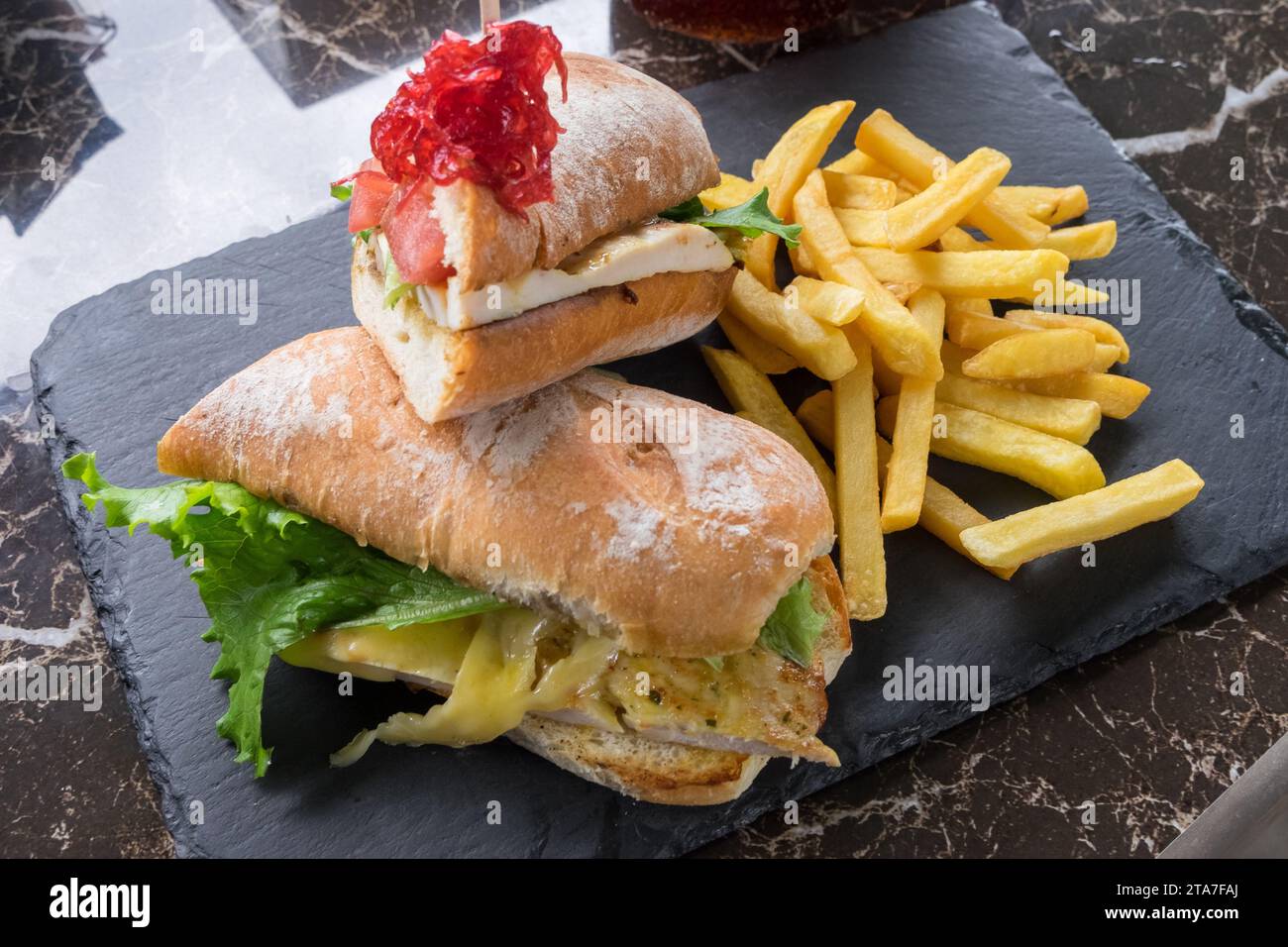 Chicken sandwich with salad and fries in Costa Rica Stock Photo - Alamy
