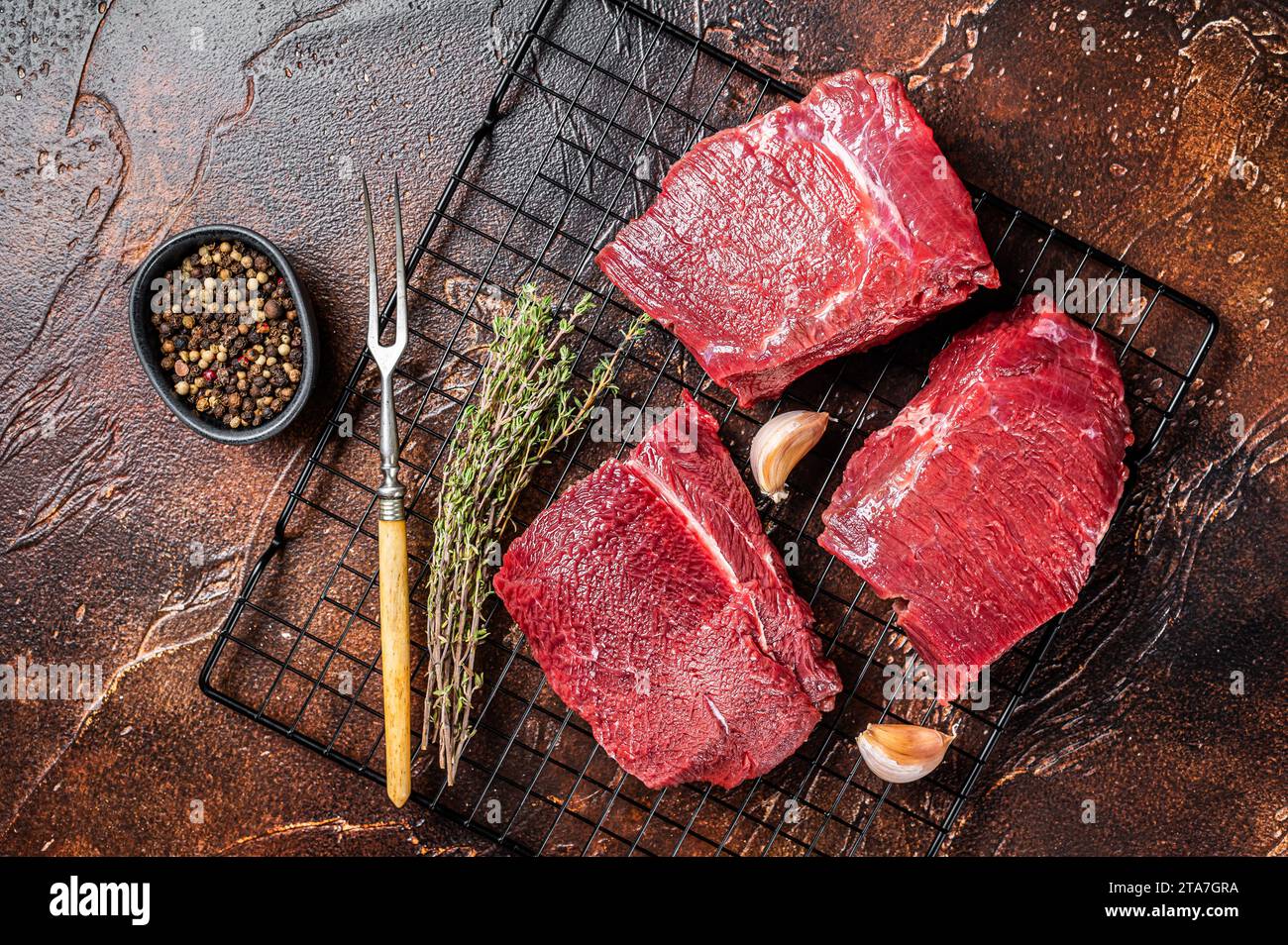 Raw Wild Game Meat of Venison dear ready for cooking. Dark background ...