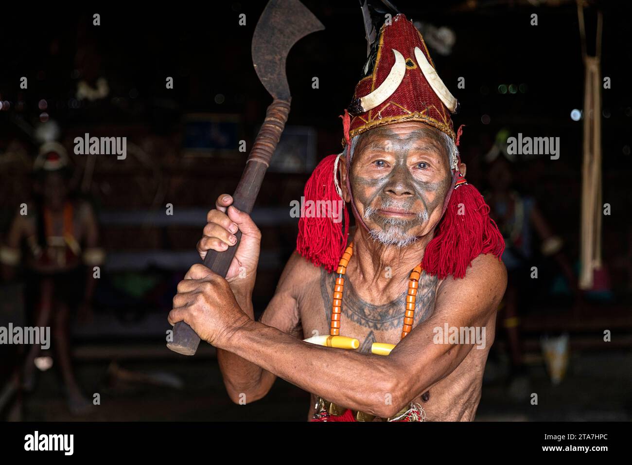 Elder warrior from Konyak tribe in traditional clothes with tattooed ...