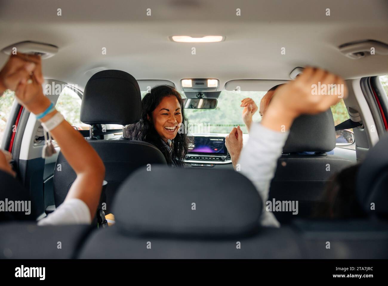 Happy parents having fun with daughters in car during road trip Stock ...