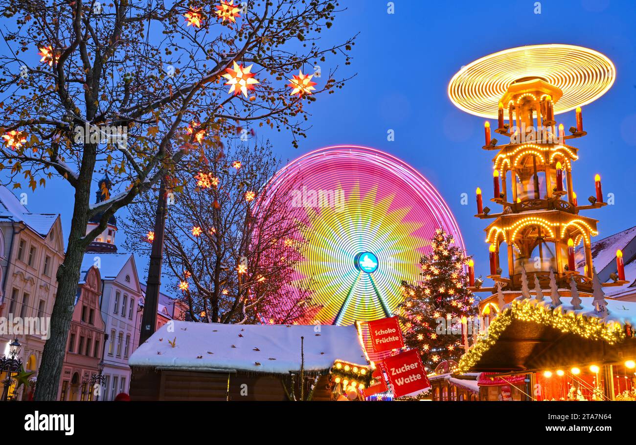 Cottbus, Germany. 29th Nov, 2023. A Ferris wheel and a pyramid turn at ...