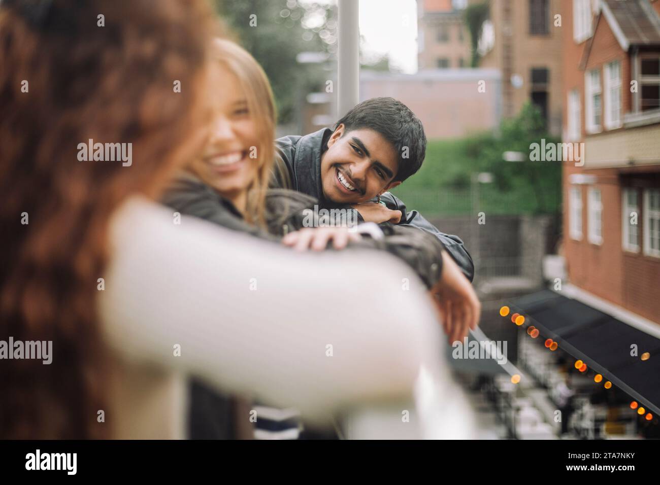 Boy leaning railing outdoors hi-res stock photography and images - Alamy