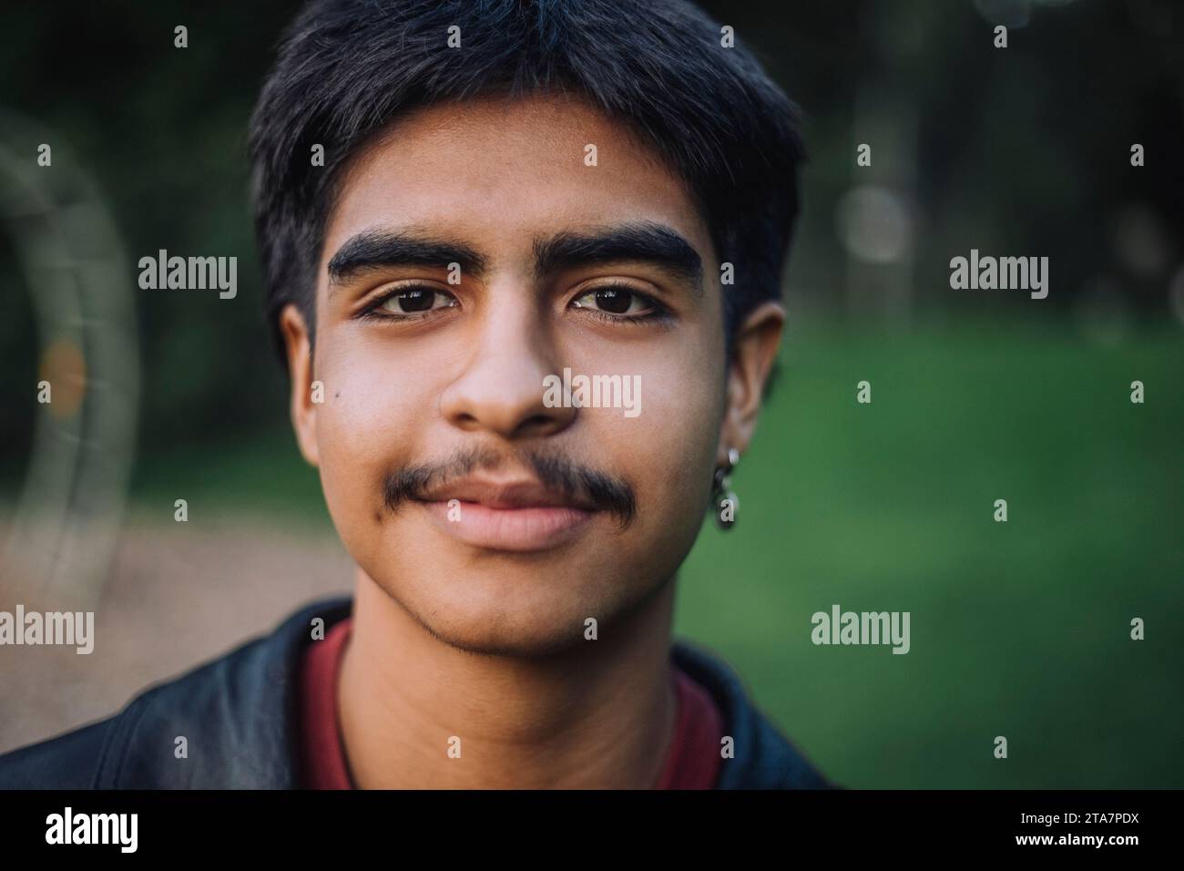 Portrait of smiling teenage boy with mustache Stock Photo - Alamy