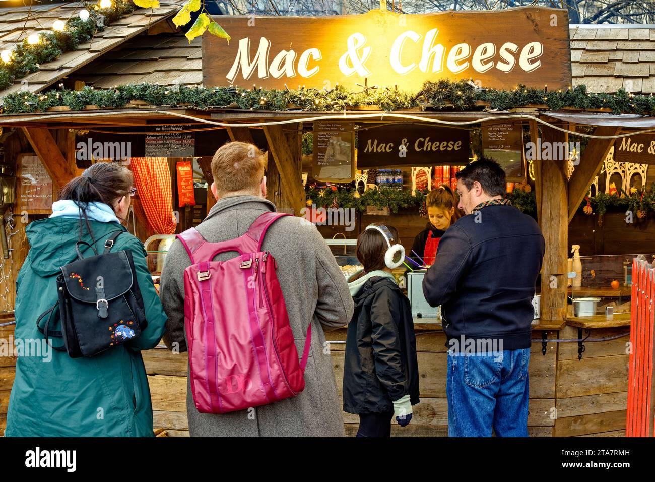 Edinburgh Scotland Christmas Fair or Market Princes Street people at the Mac and Cheese stall ...