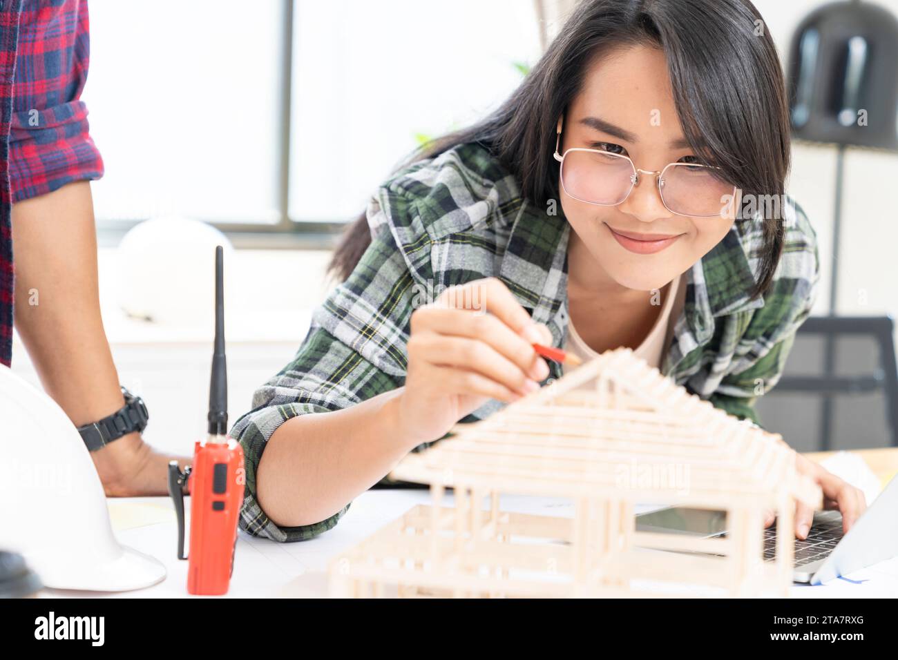 The female architect is working with a model of a house in the office Stock Photo - Alamy