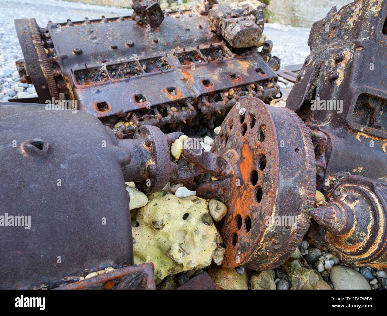 Rusty remains of motor of a shipwreck on a beach near Fecamp (France ...