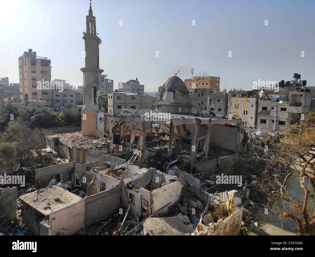 Palestinians walk among the rubble in the residential area Jabalia camp ...