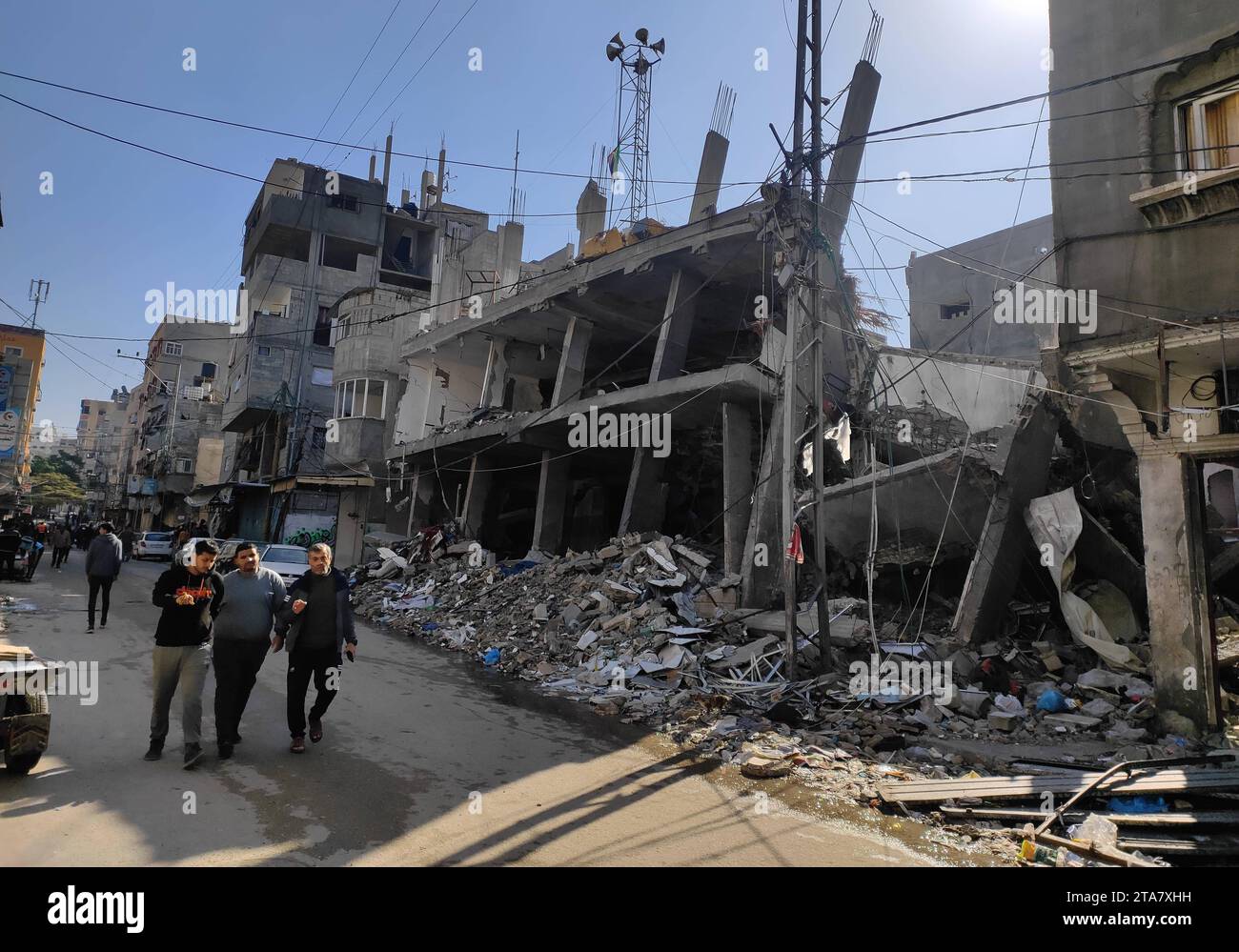 Palestinians walk among the rubble in the residential area Jabalia camp ...