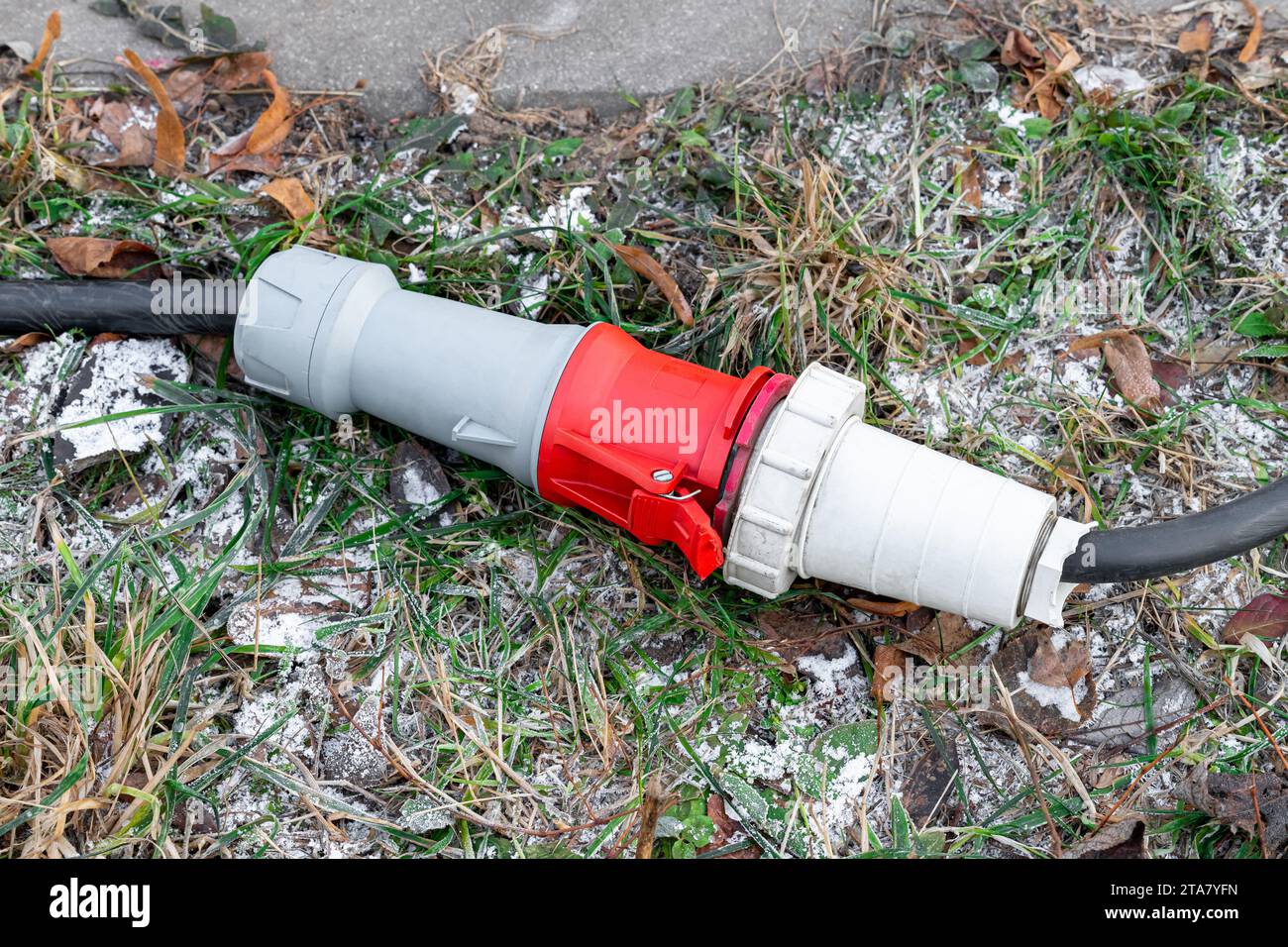 The power supply connection for outdoor equipment lies on the ground ...
