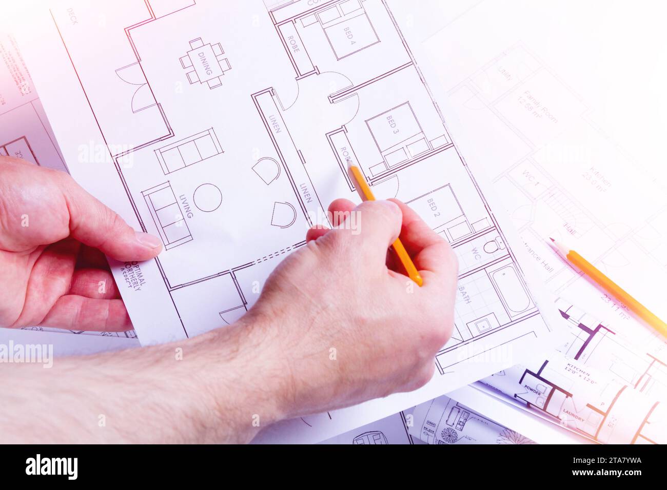 Builder's hands on the background of a house plan. Construction ...