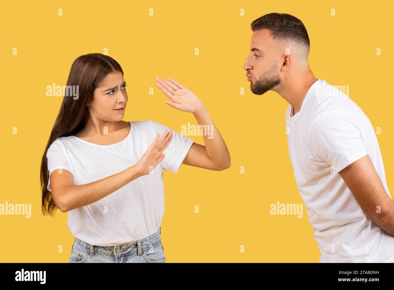 Angry millennial european woman in white t-shirt stop man, wants kiss ...