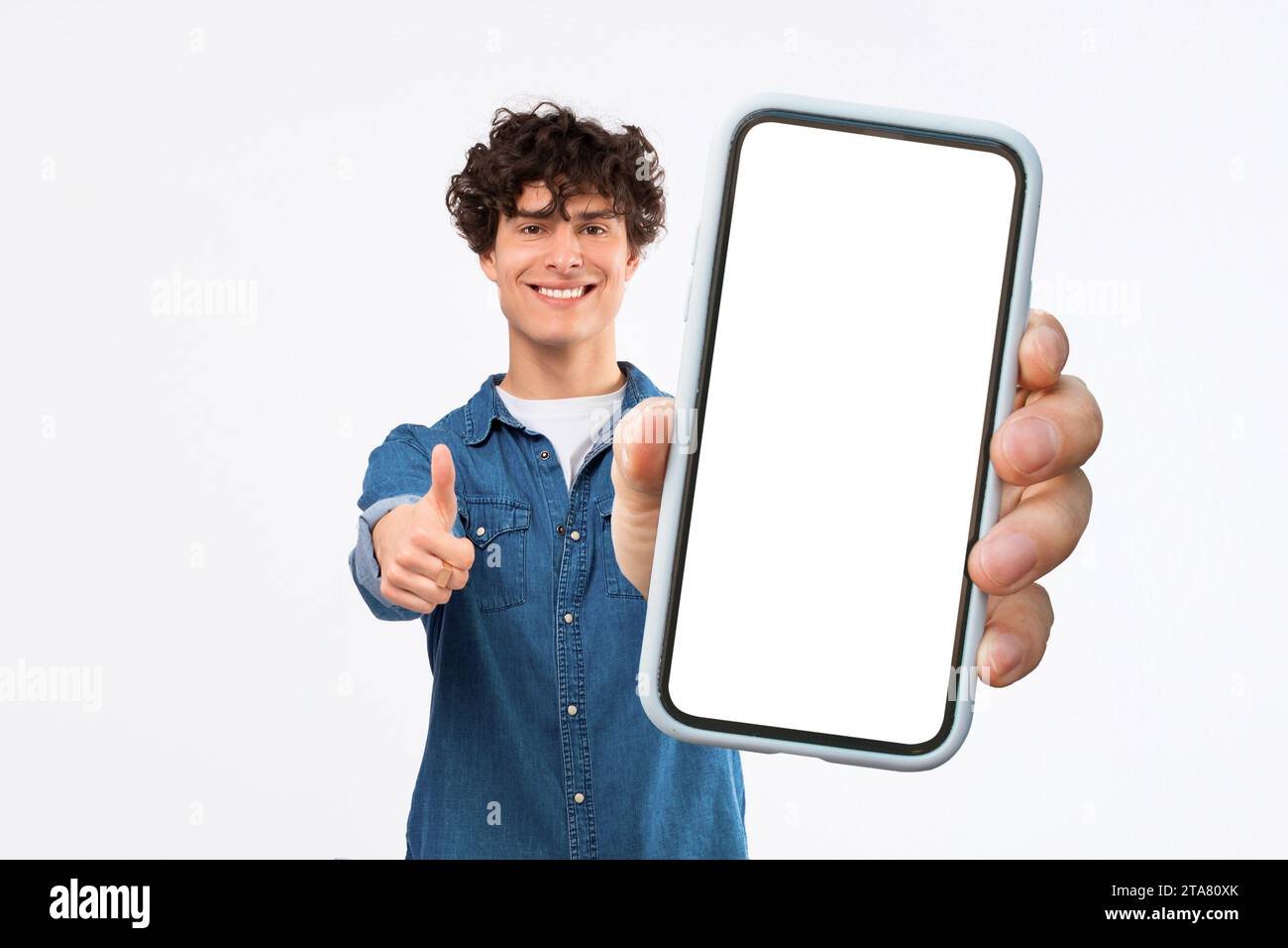 Man Poses Holding Huge Smartphone Advertising Empty App Screen, Studio ...