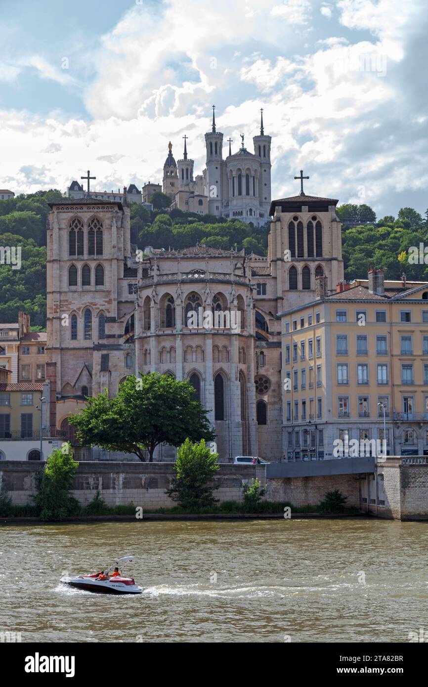 Lyon, France - June 10 2018: Small boat passing by the Cathédrale Saint ...