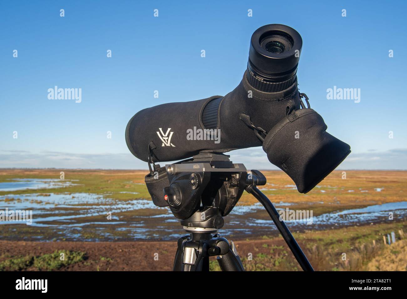 Birdwatcher’s telescope and view over salt marsh of the Western Scheldt ...