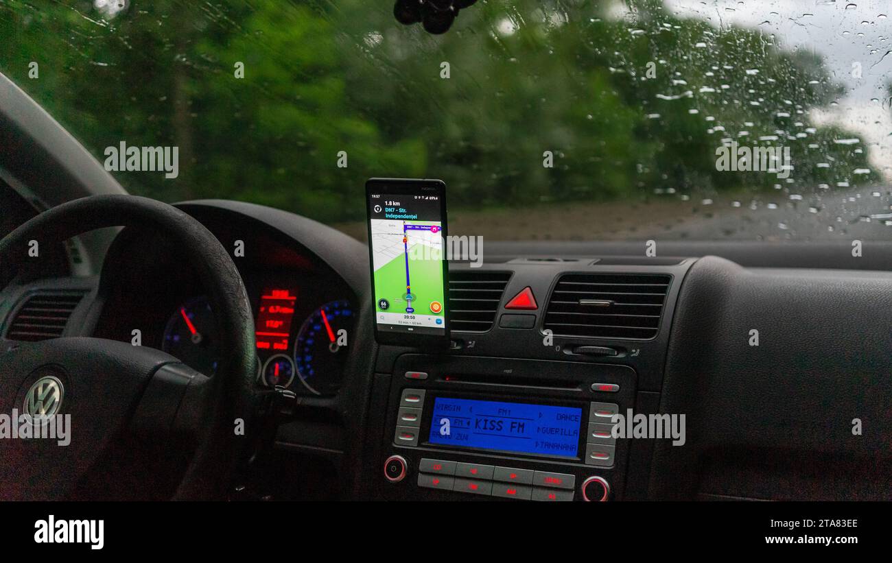Smartphone showing Waze maps to show the way thru the city. Driver ...