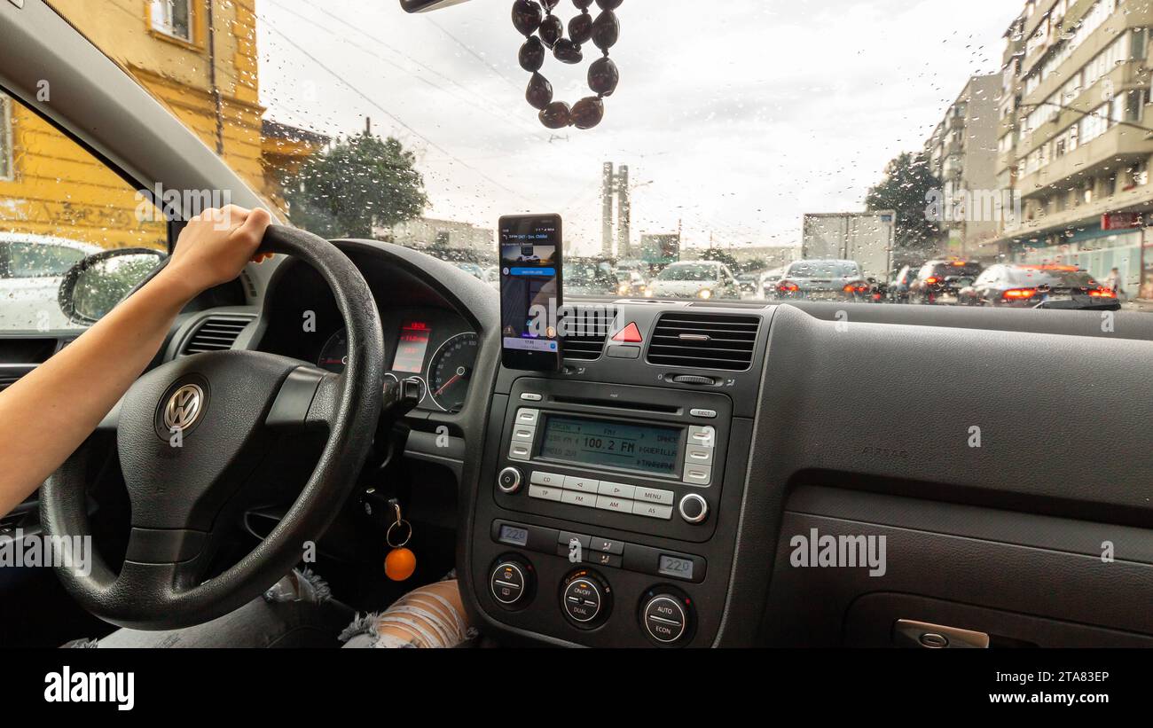 Smartphone showing Waze maps to show the way thru the city. Driver ...